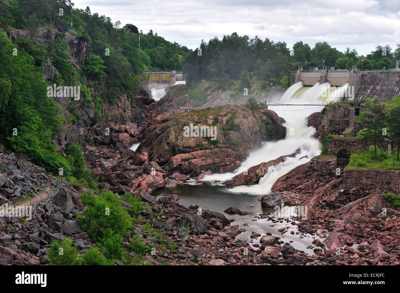 Dam and a waterfall through rocky cliffs Stock Photo - Alamy
