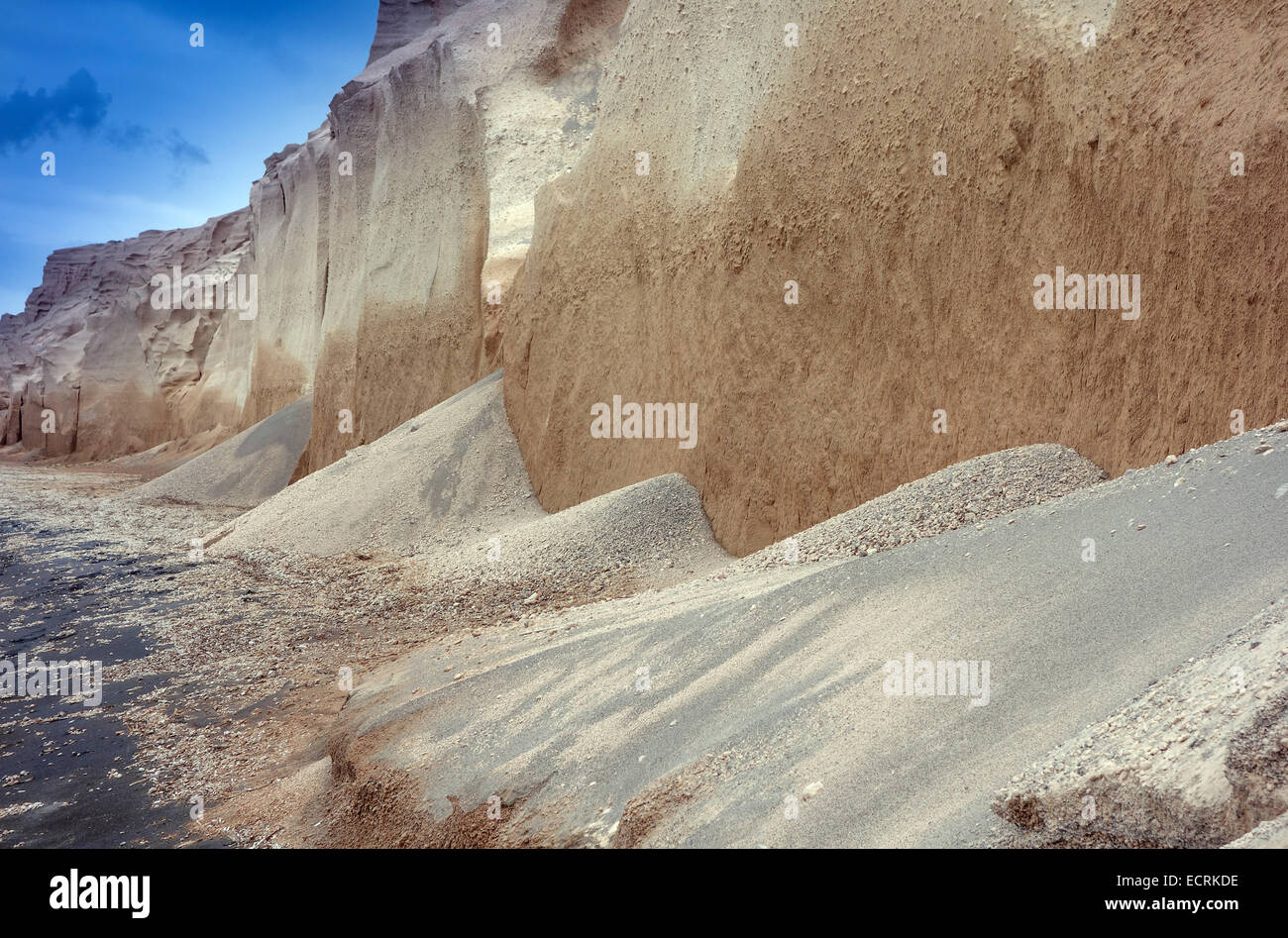 Eroded cliffs of volcanic ash and cones of debris, Santorini, Greece ...