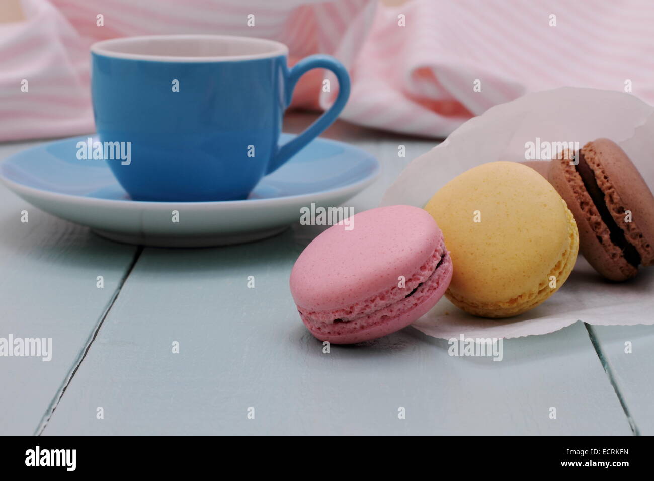 Tracing paper cornet with macarons and blue Espresso Cup, close up ...