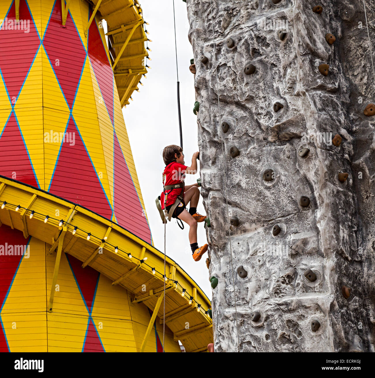 Child on climbing wall at fun fair, Cardiff Bay, Wales, UK Stock Photo ...