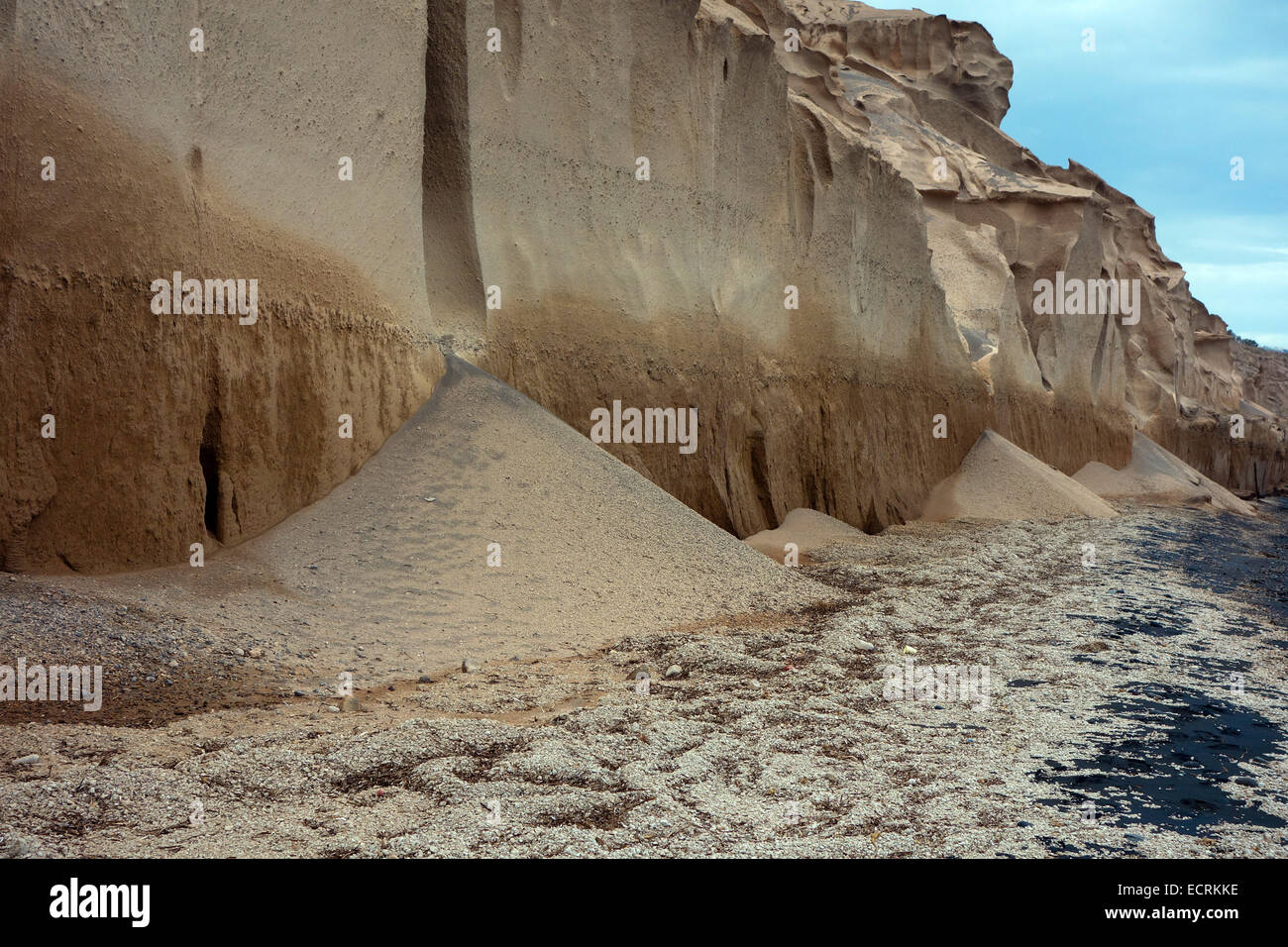 Eroded cliffs of volcanic ash and cones of debris, Santorini, Greece ...