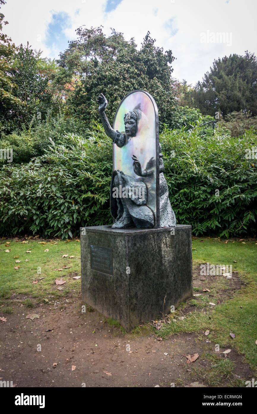 Statue depicting Alice through the looking glass in public park ...