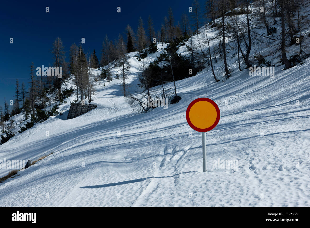 Beautiful winter landscape with snow covered road and traffic sign ...