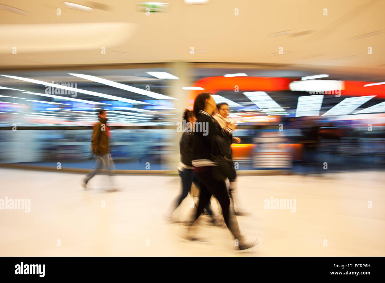 A shopper walking past a store window Stock Photo - Alamy