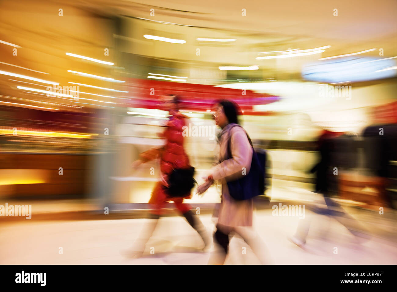 Young women walking past display windows Stock Photo - Alamy