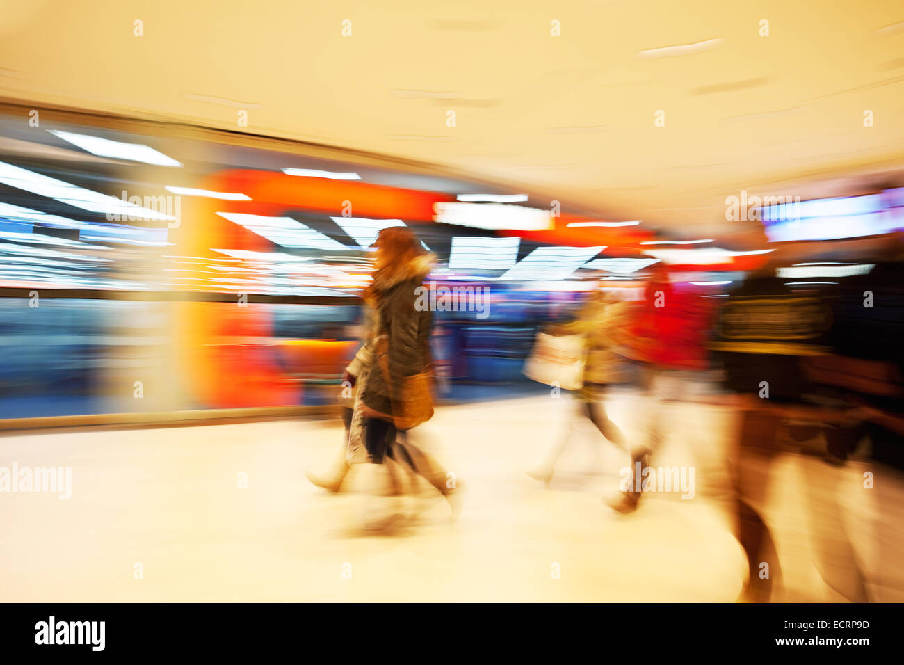 Young women walking past window display in clothes shop Stock Photo - Alamy