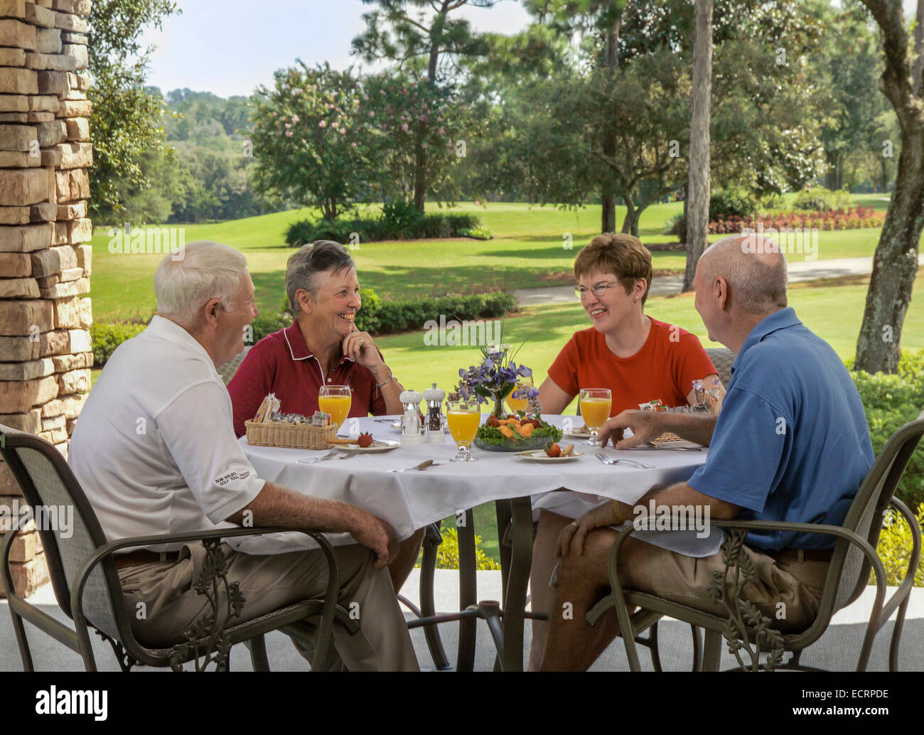 Senior couples dining, outside country club setting Stock Photo - Alamy