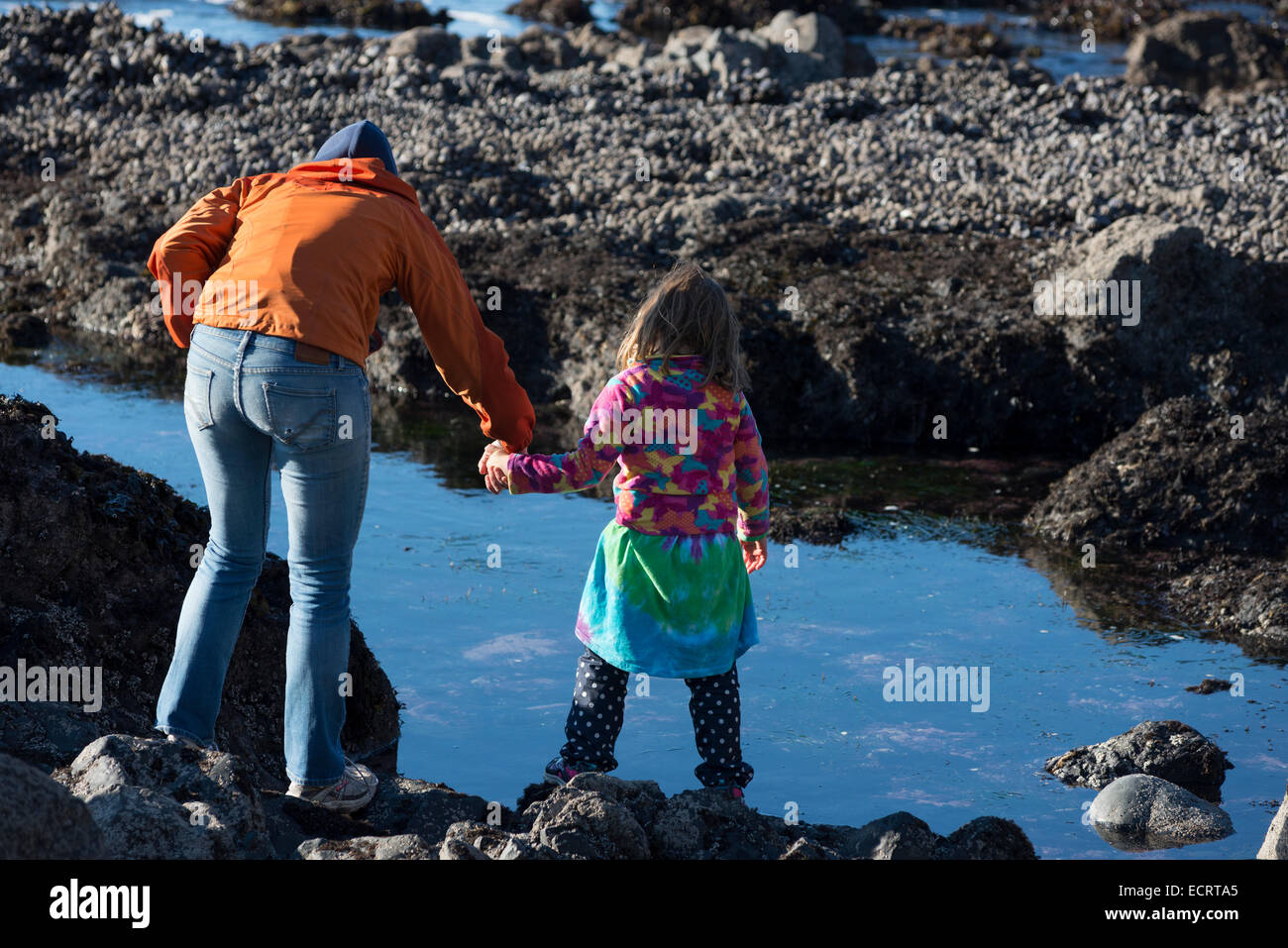 Mother and daughter exploring tidepools at the Yaquina Head Outstanding ...