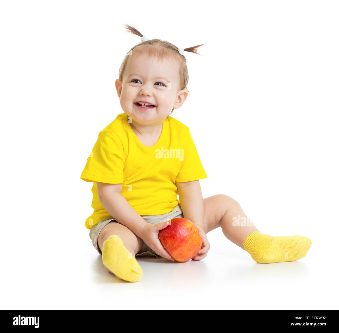 Baby eating apple sitting isolated on white Stock Photo - Alamy