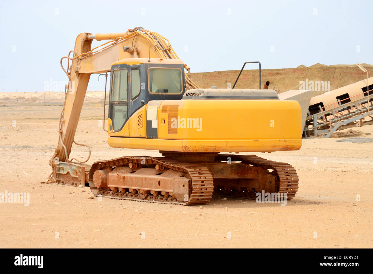 An excavator parking in an industrial site platform Stock Photo - Alamy