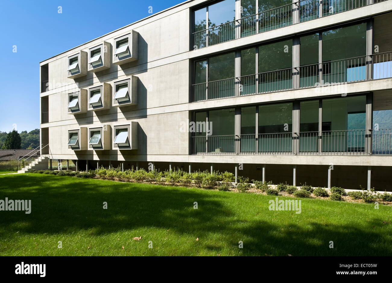 cement building exterior window grass sky Stock Photo - Alamy