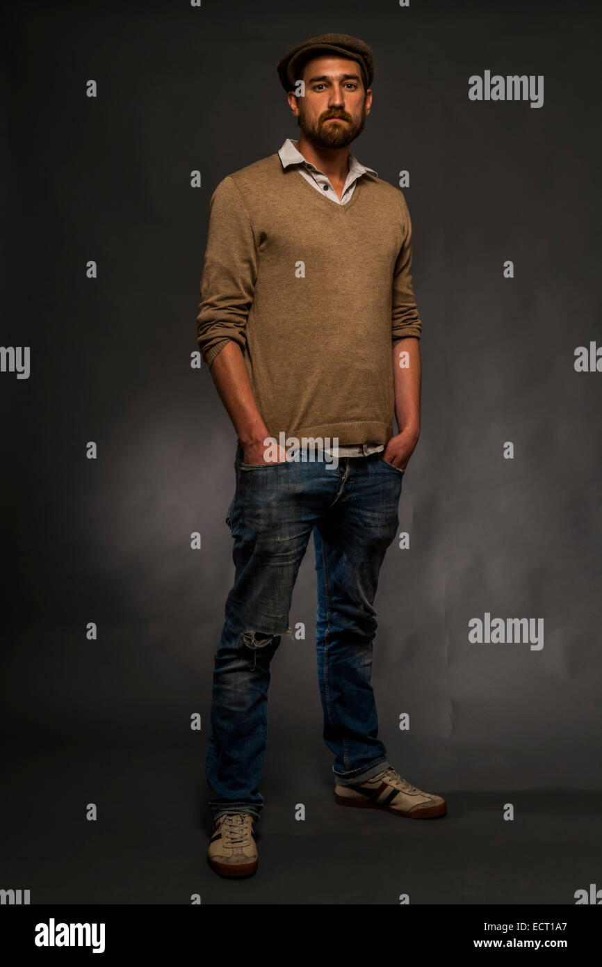 Portrait of man with hands in his pockets wearing cap Stock Photo - Alamy