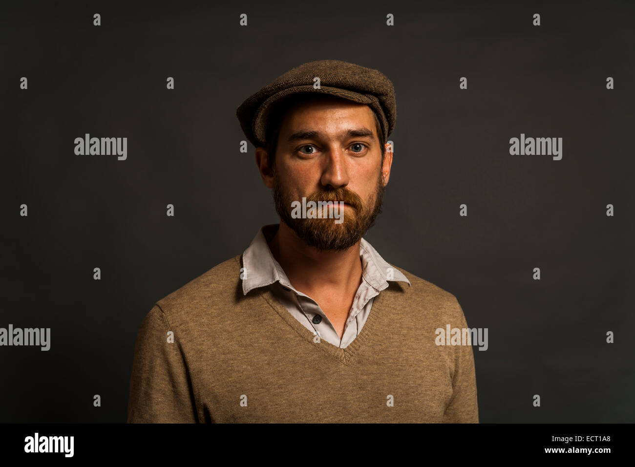 Portrait of seious looking man with full beard wearing cap Stock Photo ...