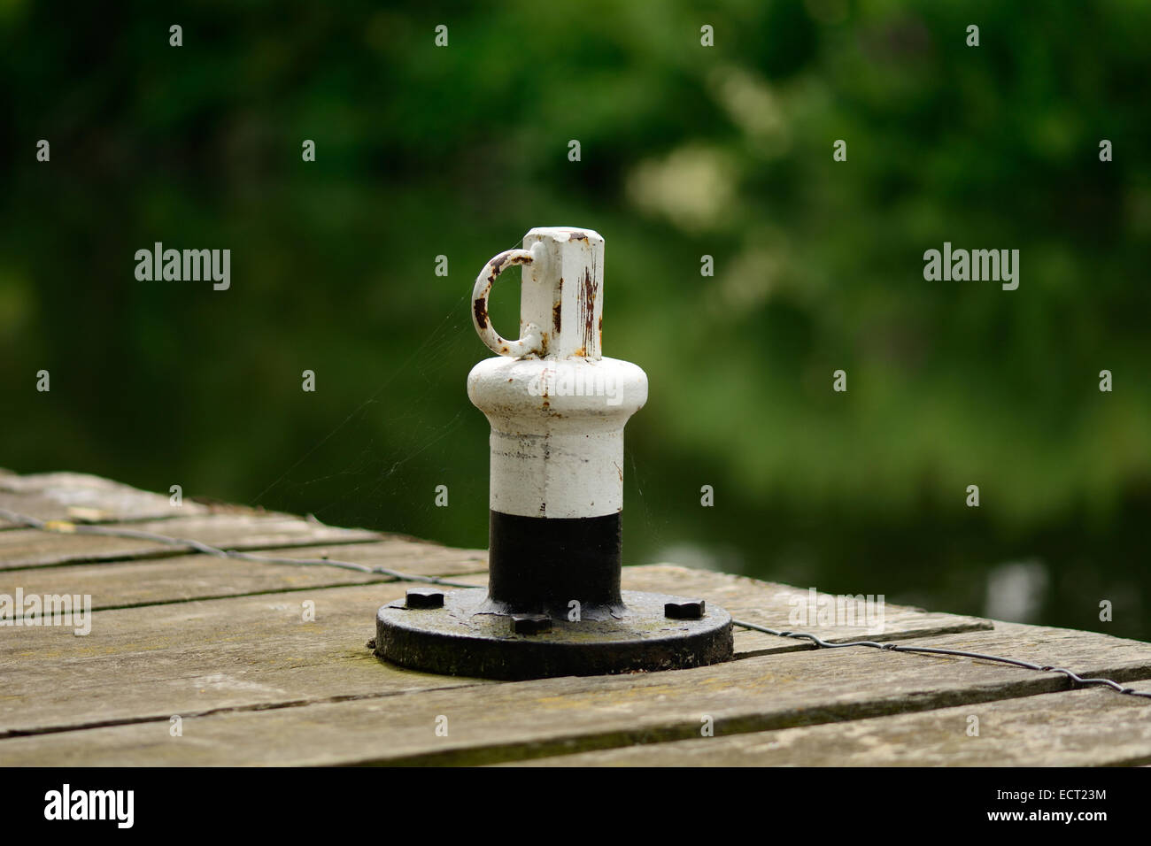 Boat mooring post on riverbank Stock Photo - Alamy