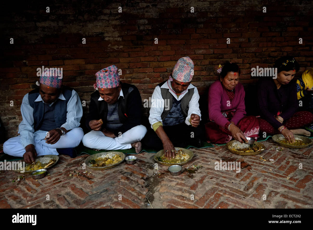 Nepali villagers eating with their hands in the village of Bungamati a ...