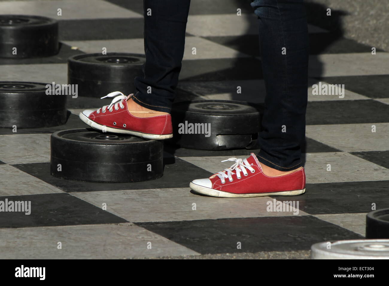 Female red shoes playing at a giant outdoor checkers Stock Photo - Alamy