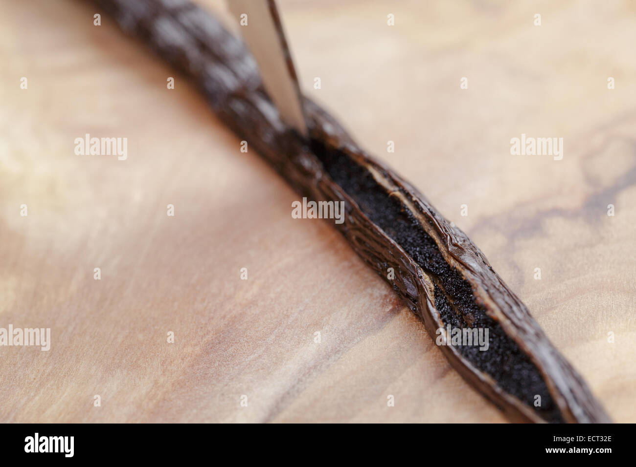 open vanilla pod on olive board, close up photo Stock Photo - Alamy