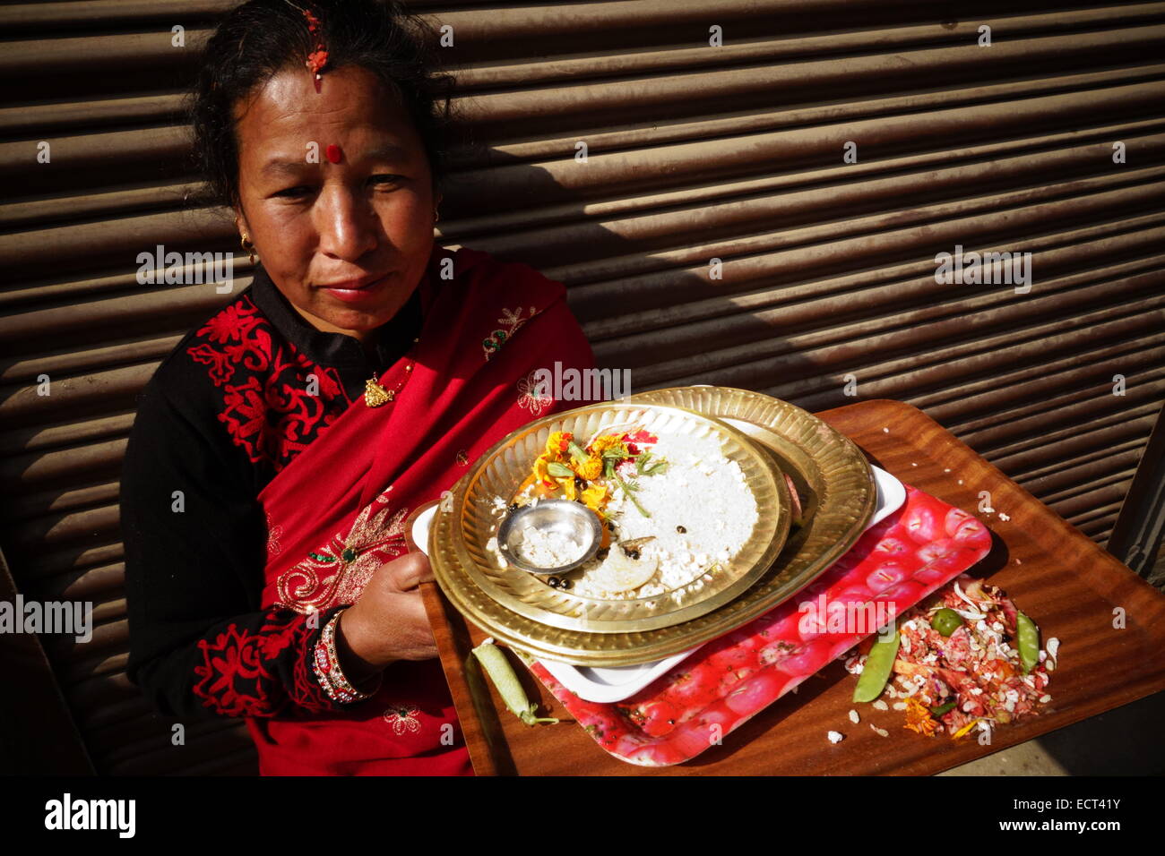 Nepali woman carrying religious offering during a ritual process in the ...