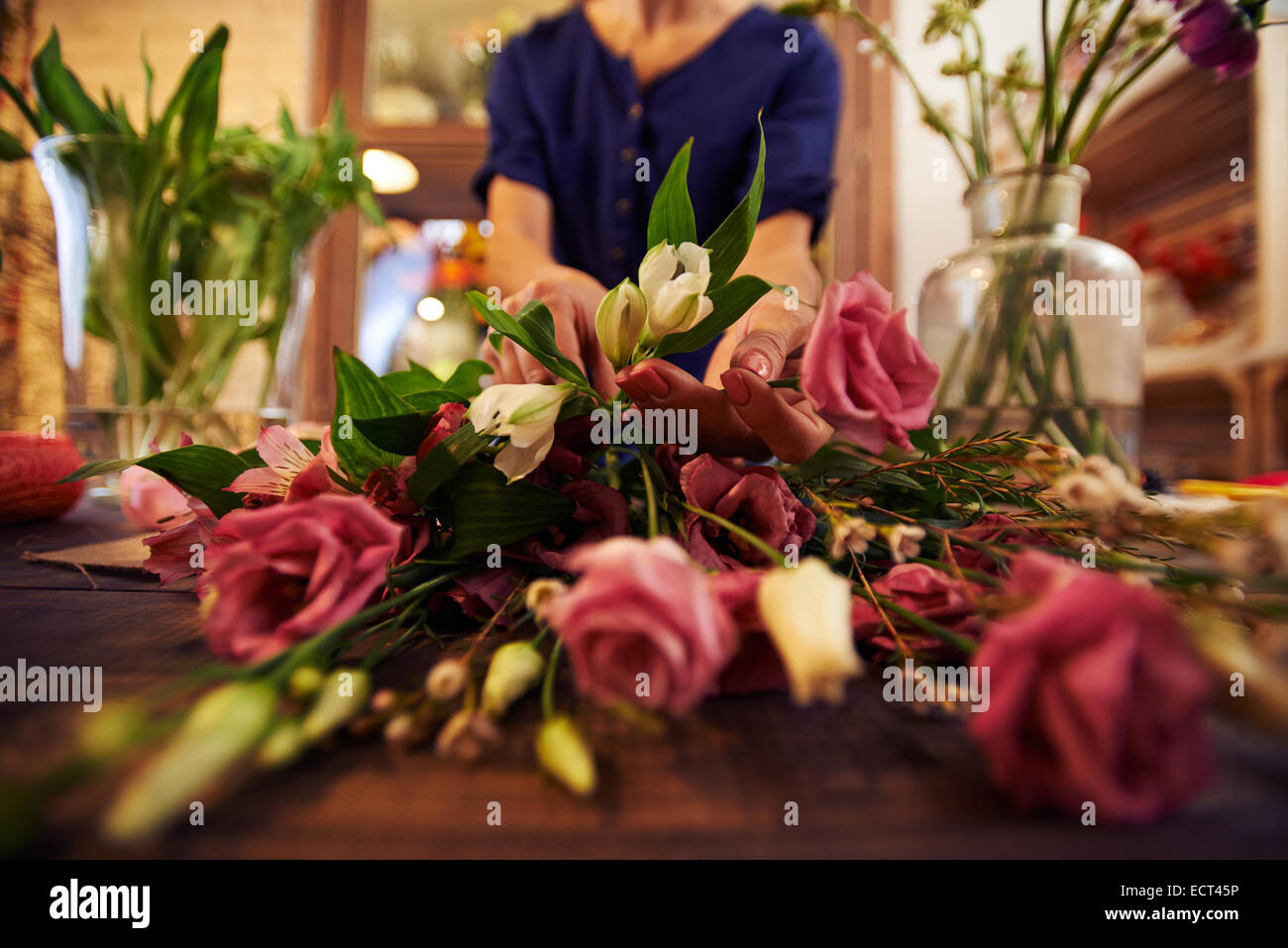 Female florist sorting fresh flowers in workshop Stock Photo - Alamy