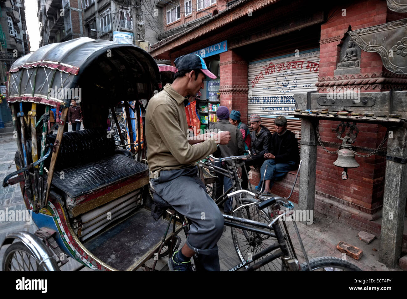 A man rides a taxi rickshaw in downtown Kathmandu Nepal Stock Photo - Alamy