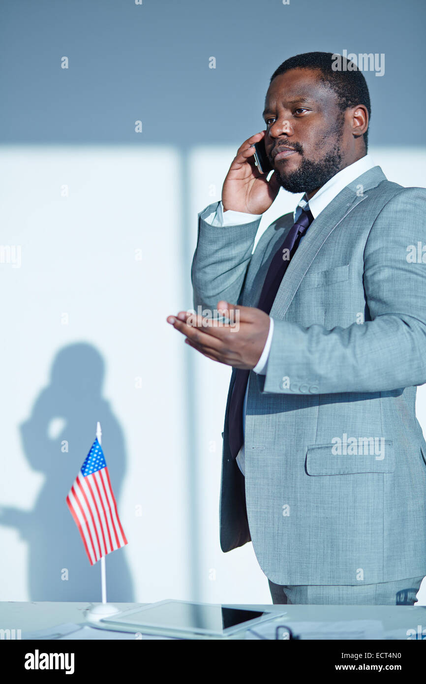 Serious boss talking to employee on the phone Stock Photo - Alamy