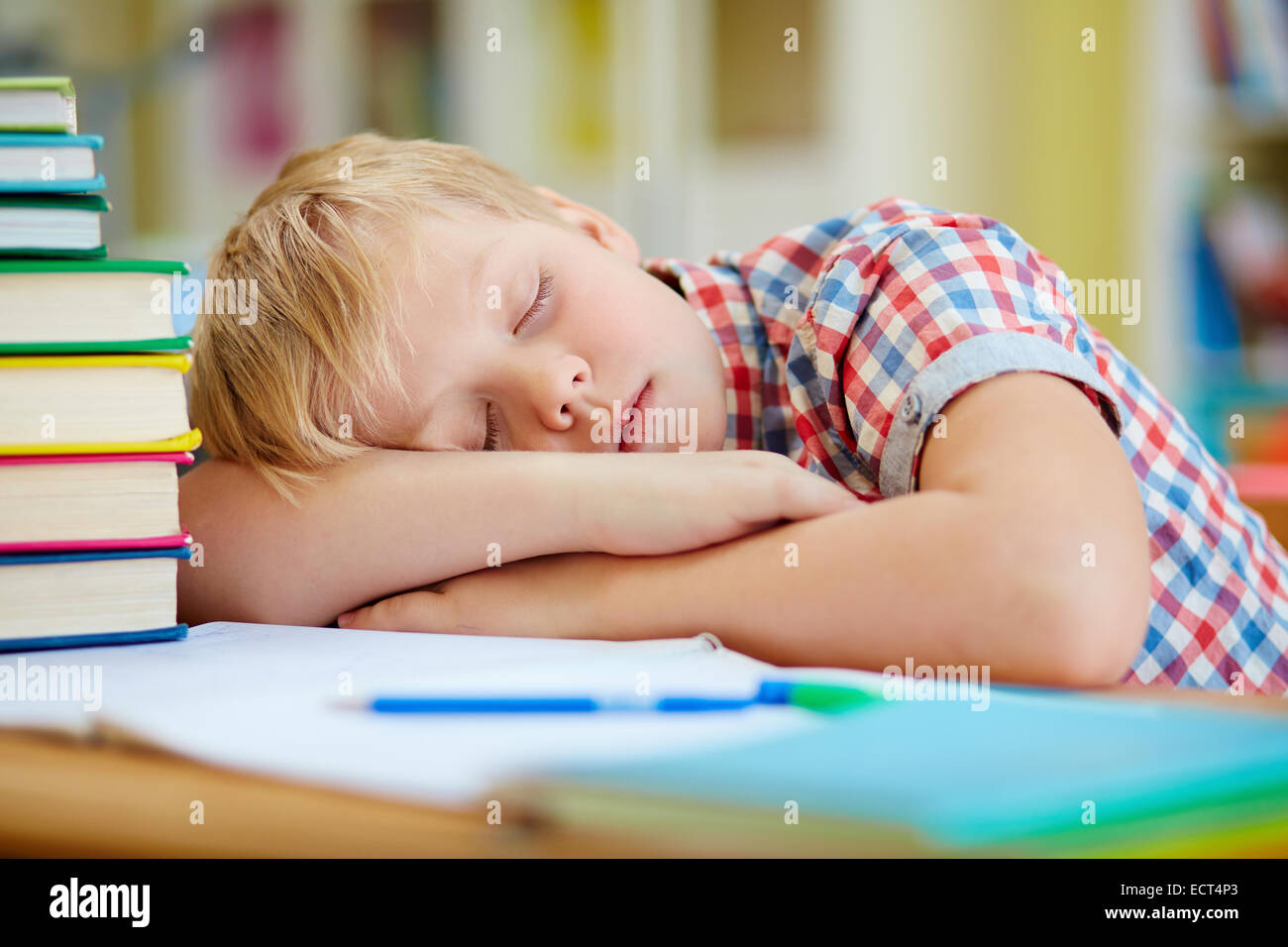 Tired elementary learner sleeping in classroom Stock Photo - Alamy