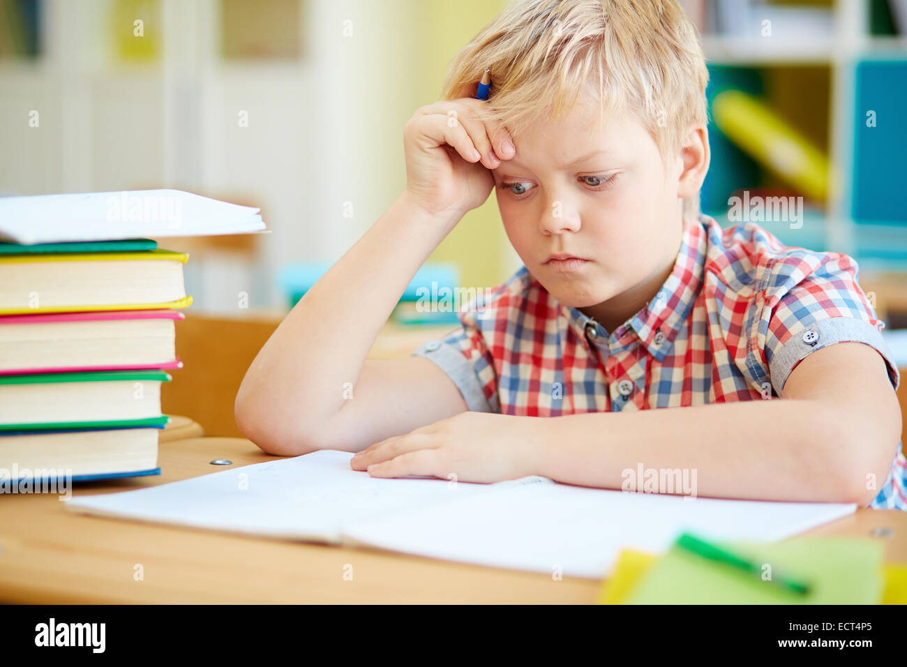 Handsome little boy thinking of right answer Stock Photo - Alamy