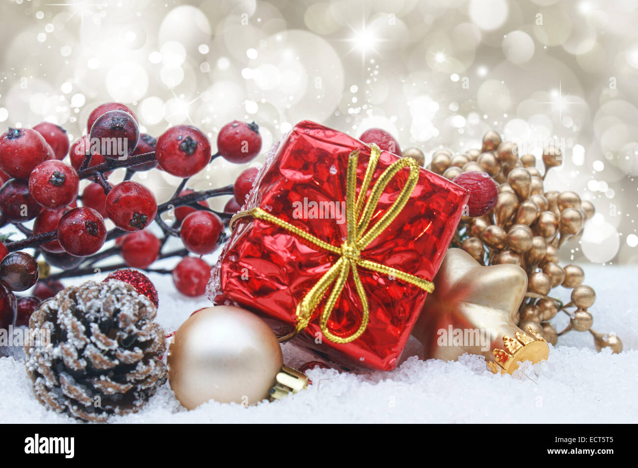 Christmas gift and decorations nestled in snow Stock Photo - Alamy