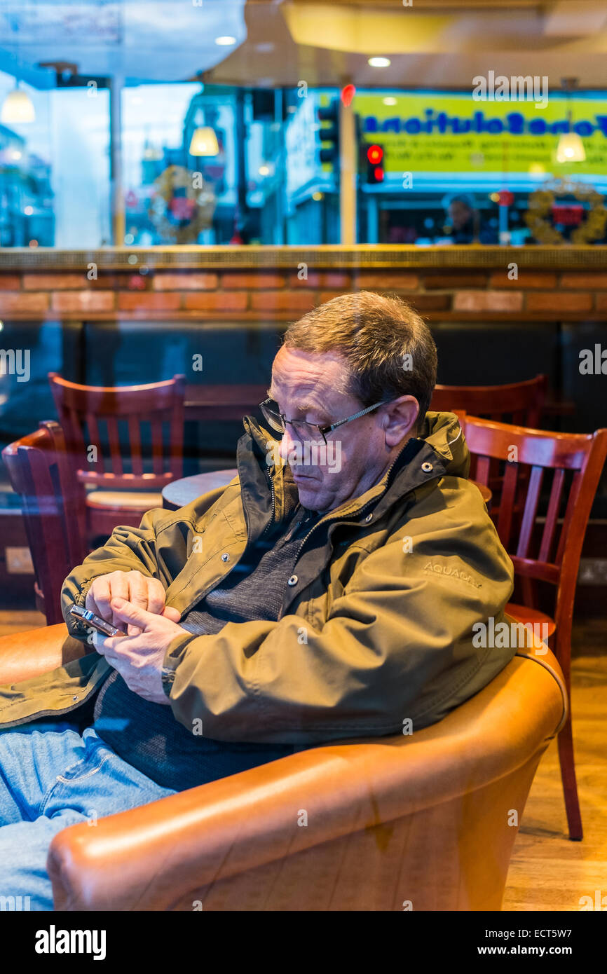 man in coffee shop using smart phone Stock Photo - Alamy