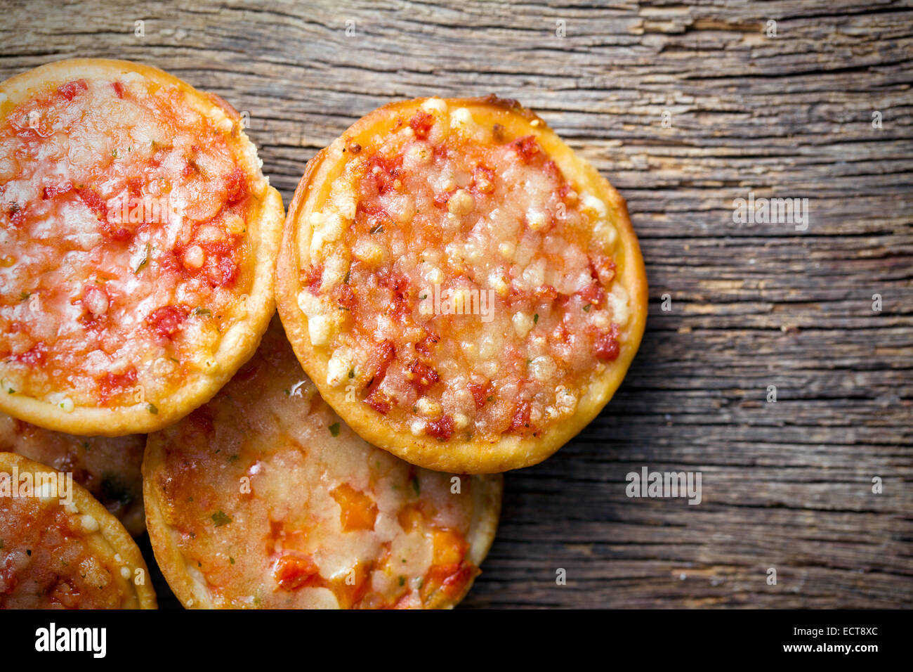 top view of mini pizza on wooden table Stock Photo - Alamy