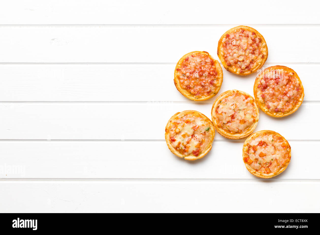 top view of mini pizza on wooden table Stock Photo - Alamy