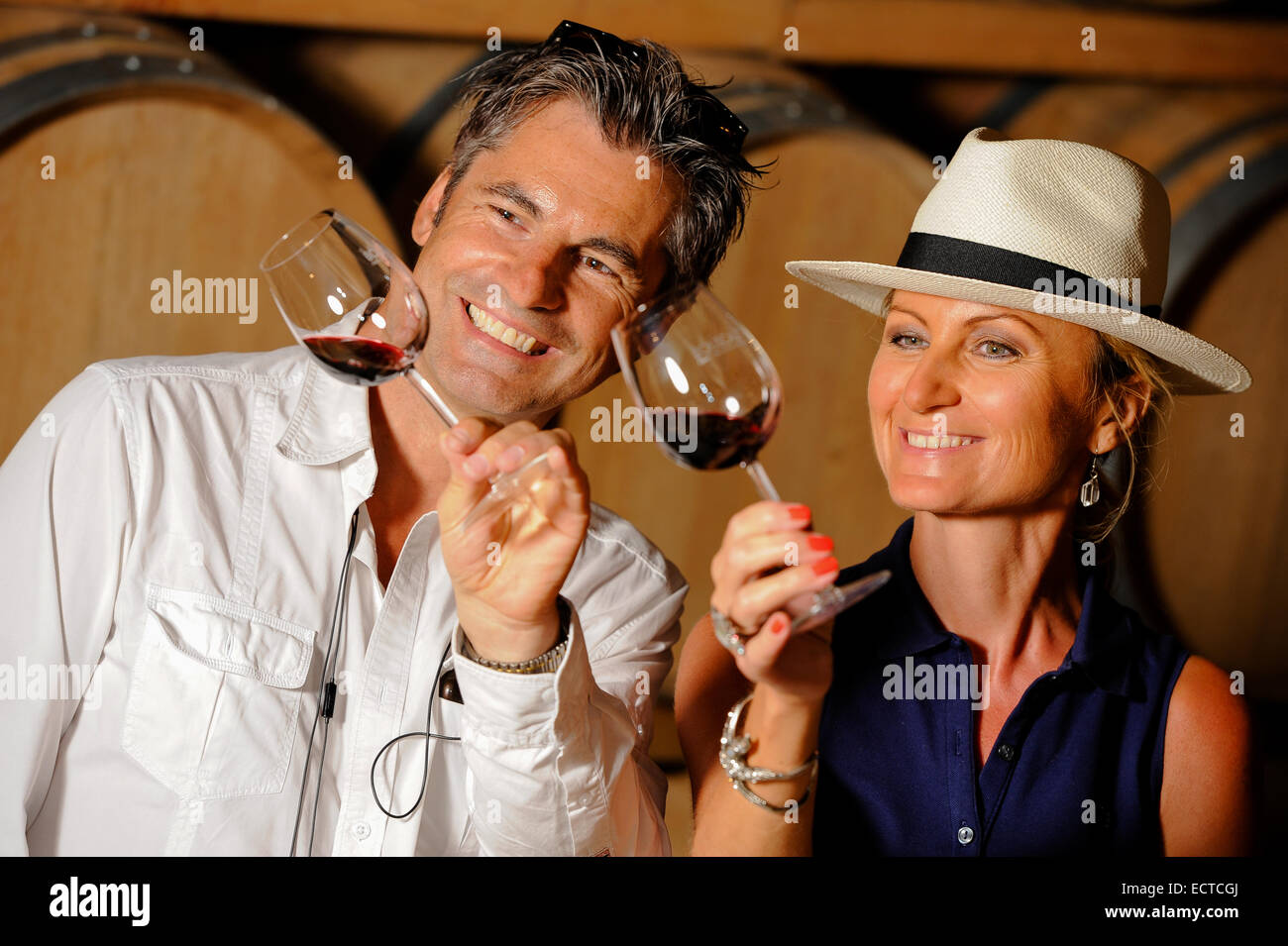 Tourism - Couple tasting wine in a cellar Stock Photo - Alamy