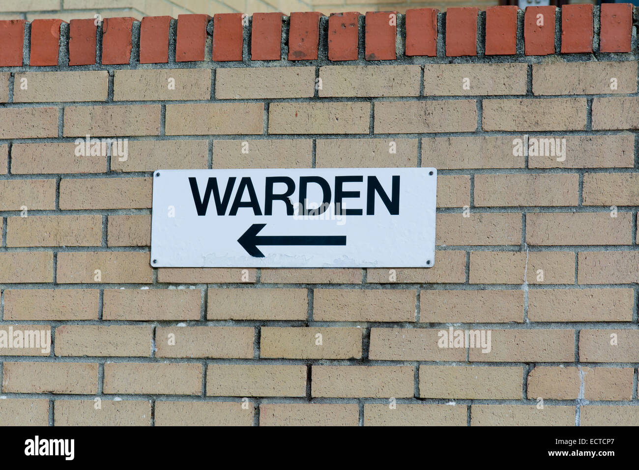 Warden sign with arrow pointing to office Stock Photo - Alamy