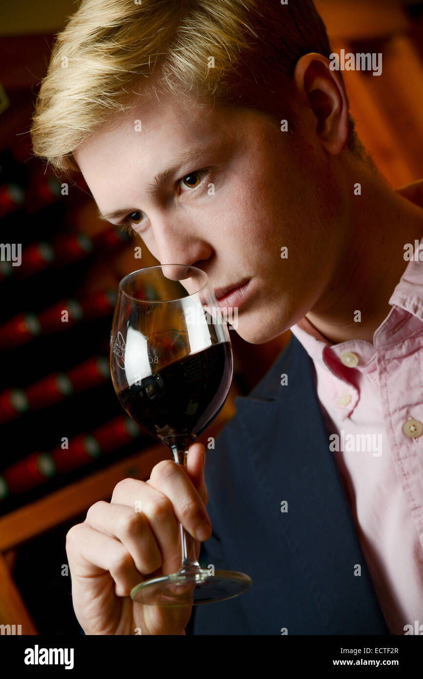 Wine Waiter tasting wine in a cellar Stock Photo - Alamy