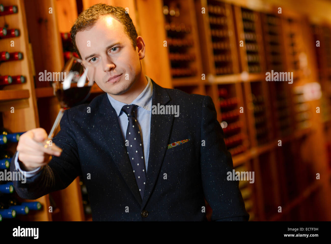 Wine Waiter tasting wine in a cellar Stock Photo - Alamy