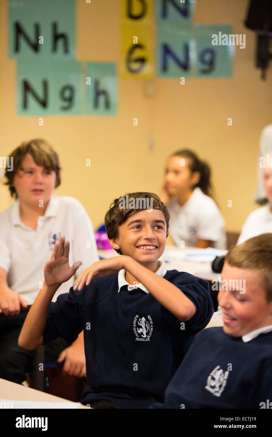 Secondary school education Wales UK: a happy smiling boy pupil answerig ...