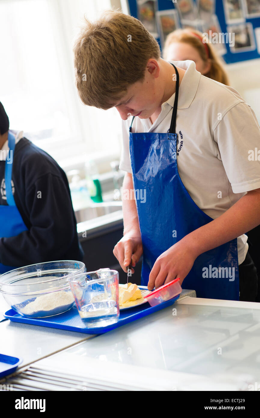Secondary school education Wales UK: A boy pupil preparing, measuring ...