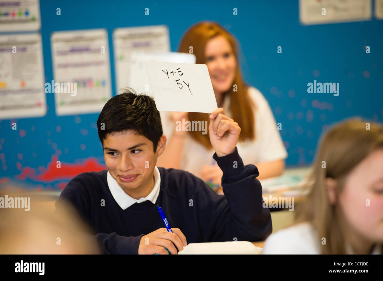 Secondary school mathematics education Wales UK: pupils holding up ...