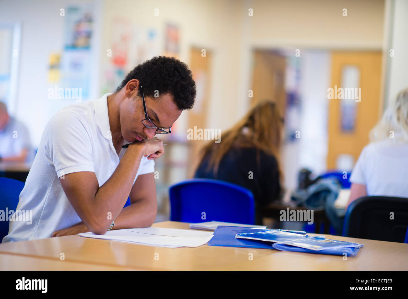 Pupils doing homework in a classroom hi-res stock photography and ...