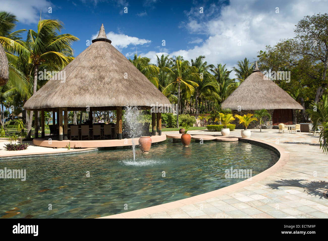 Mauritius, Flic en Flac, La Pirogue Hotel dining area in garden water ...