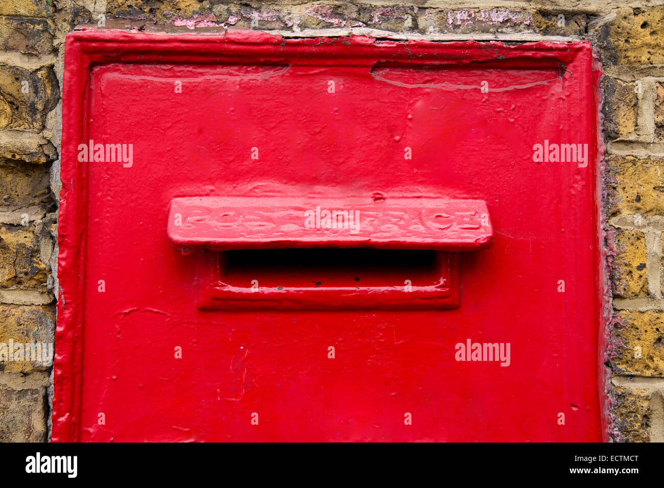 a traditional red post box in a wall Stock Photo - Alamy