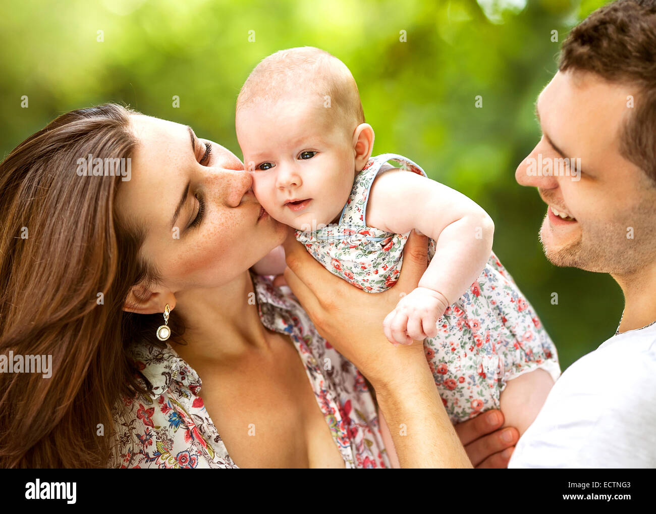 happy mother and father with baby in park Stock Photo - Alamy