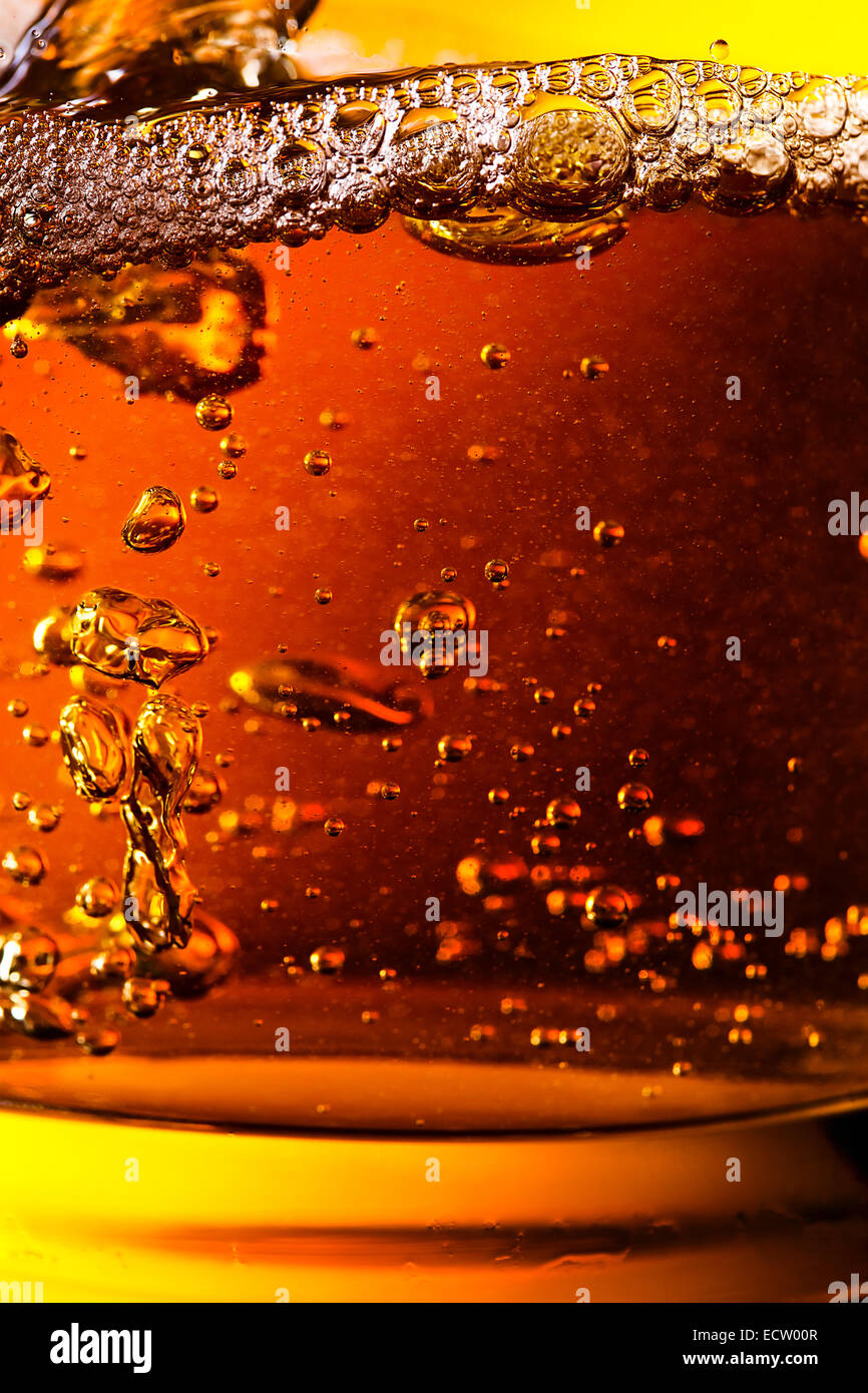 detail of an alcoholic beverage on yellow background Stock Photo - Alamy