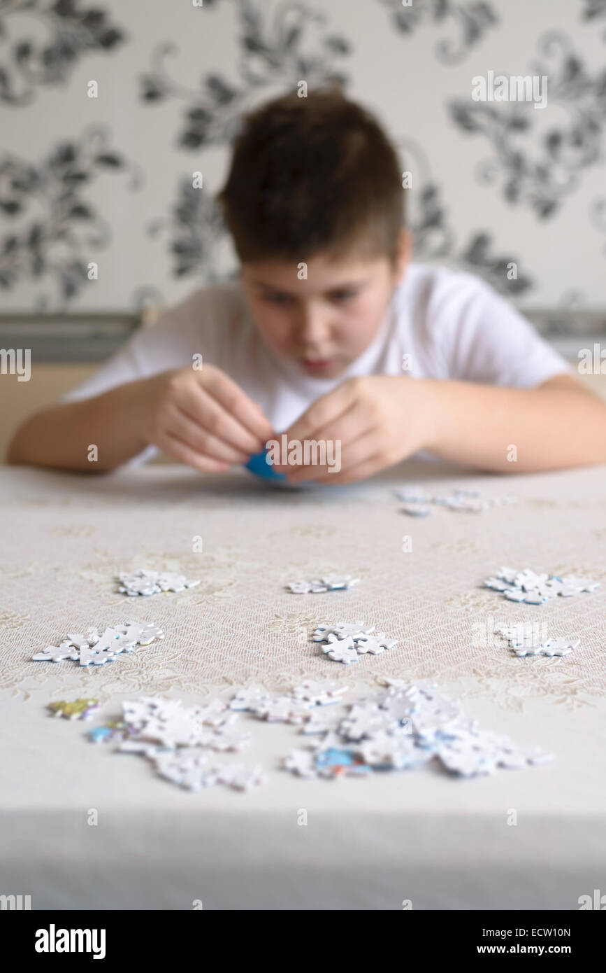 Teenager boy collects puzzles from Globe Stock Photo - Alamy