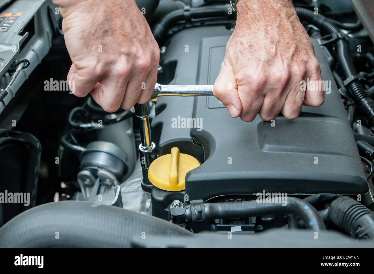 Hands repairing a car engine with a wrench Stock Photo - Alamy
