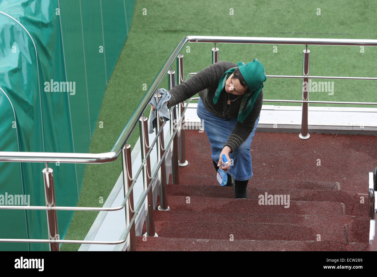 Woman cleaning the tribunes in the FC Terek football stadium in the ...