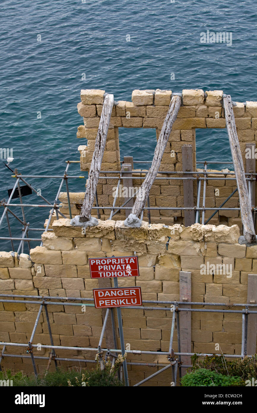 Scaffolding on a stone structure over the ocean Stock Photo - Alamy