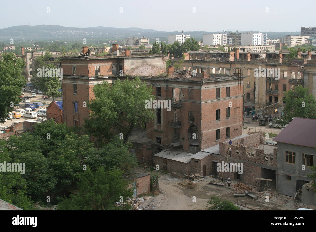 Damaged buildings and reconstruction work in the centre of the Chechen ...