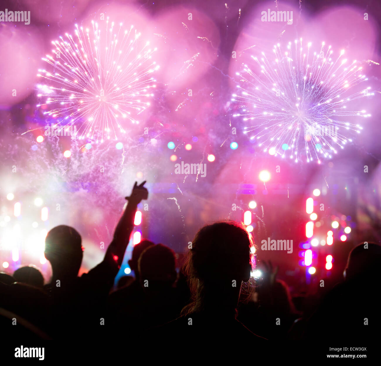 New Year concept - fireworks and cheering crowd celebrating the New ...