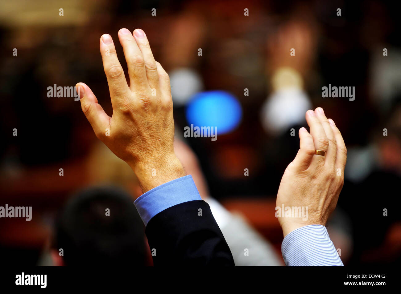 Detail shot with two raised hands expressing a vote Stock Photo - Alamy